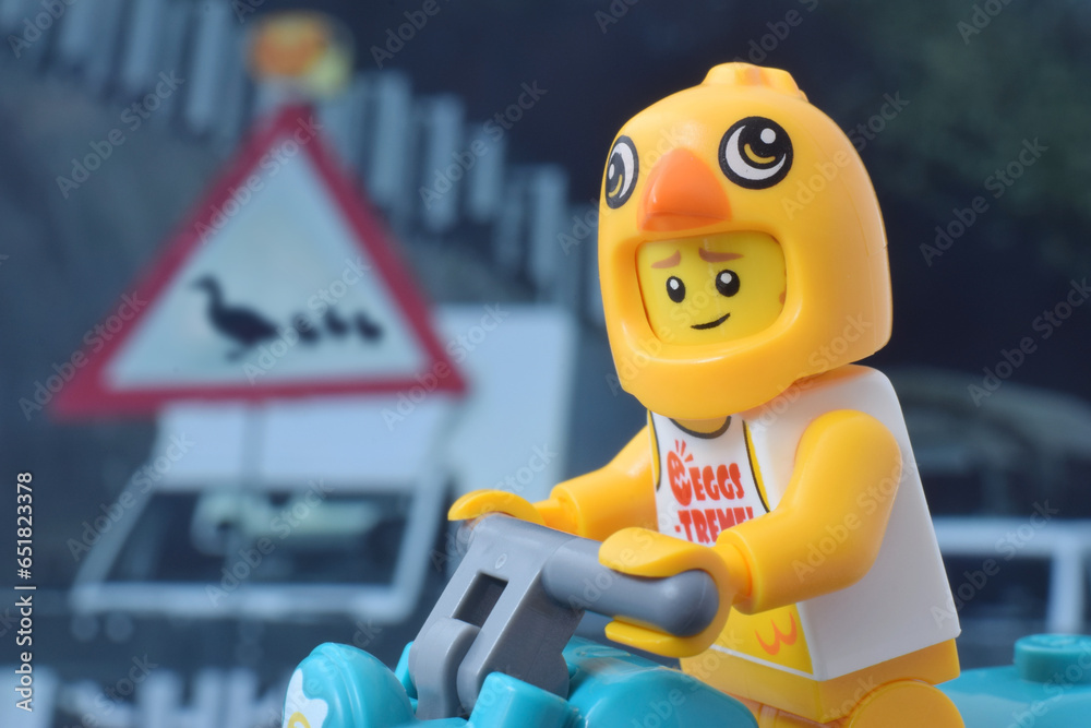 Lego minifigure of biker in yellow costume of chicken and road sign ...