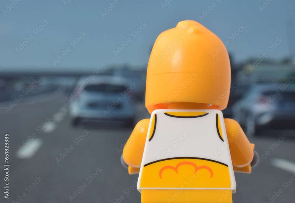 Lego minifigure of biker in yellow costume of chicken in a highway with ...