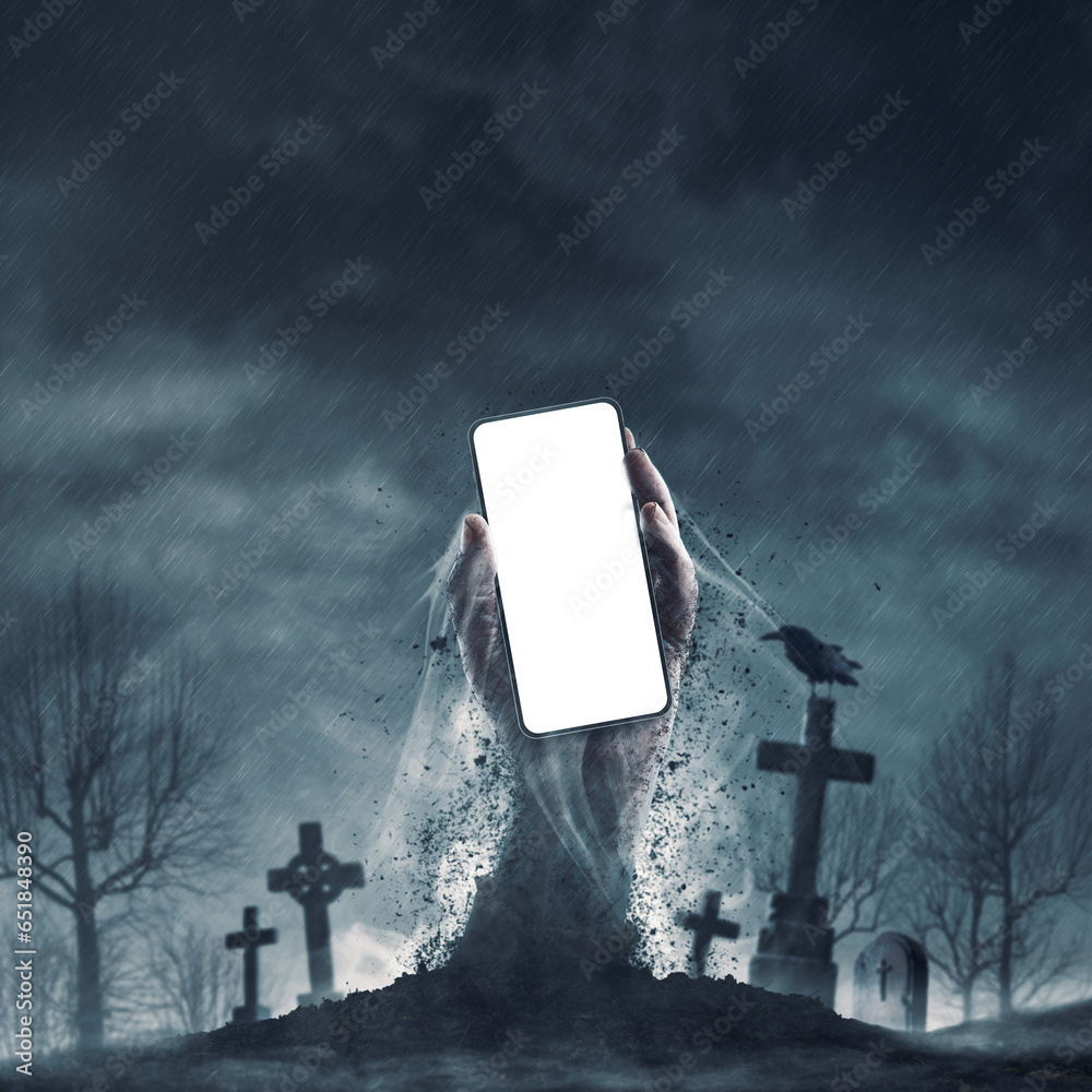 Zombie holding a smartphone in the graveyard Stock Photo | Adobe Stock
