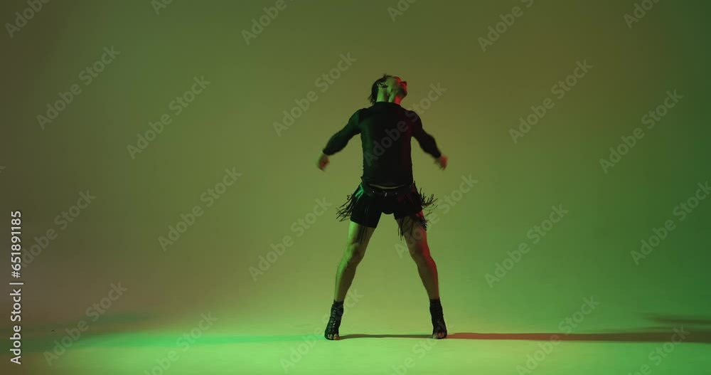 A vivid and energetic dancer of Caucasian descent delivers an ...
