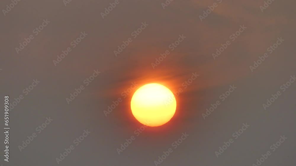 Grey and red sky around yellow solar disk with Atmospheric refraction ...