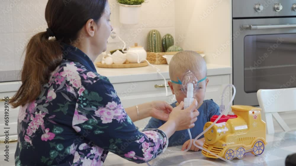 sick child crying while doing inhalation mother using nebulizer helps ...