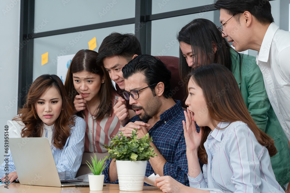 Diverse employees in office wait for the results looking from laptop ...