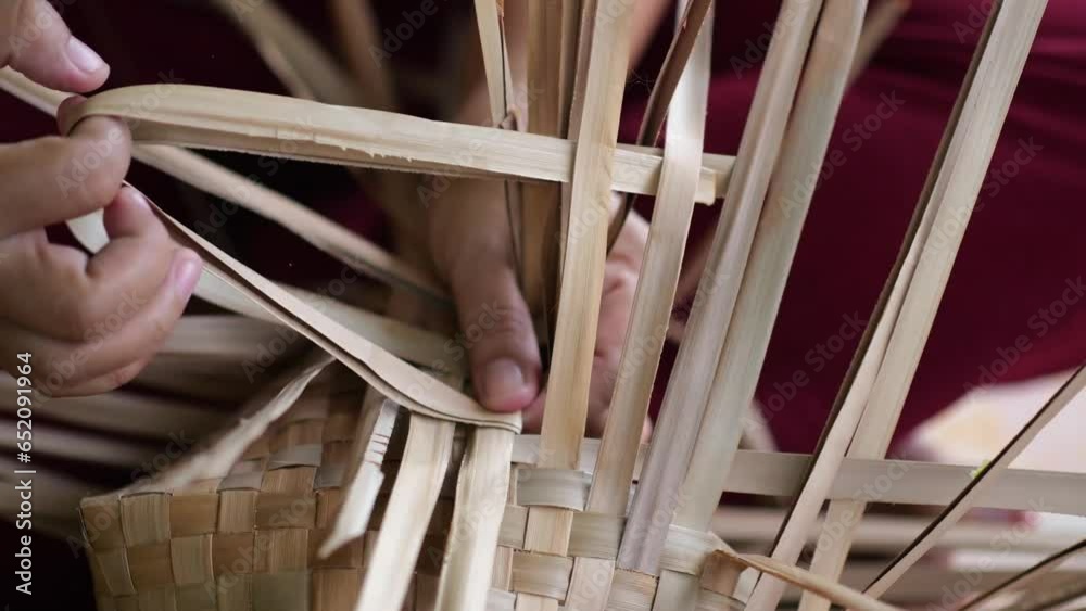 An Indonesian woman´s hand weaving an ancestral basket case from ...