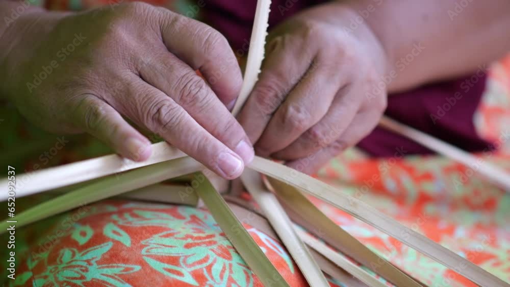 An Indonesian woman´s hand weaving an ancestral basket case from ...