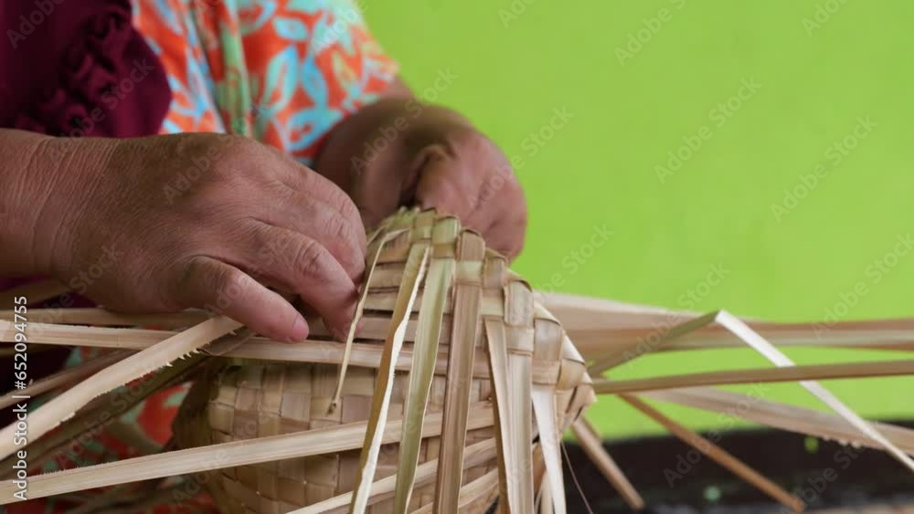 An Indonesian woman´s hand weaving an ancestral basket case from ...