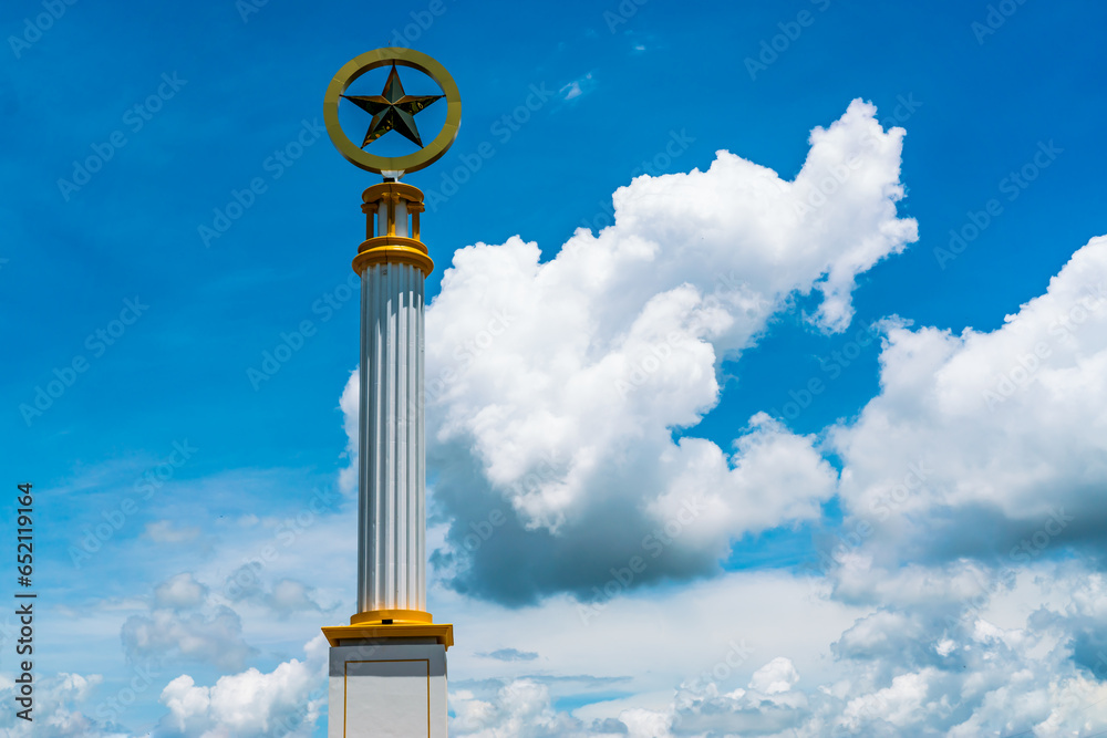 The tower is made of cement pillars and has a Christian star symbol at ...