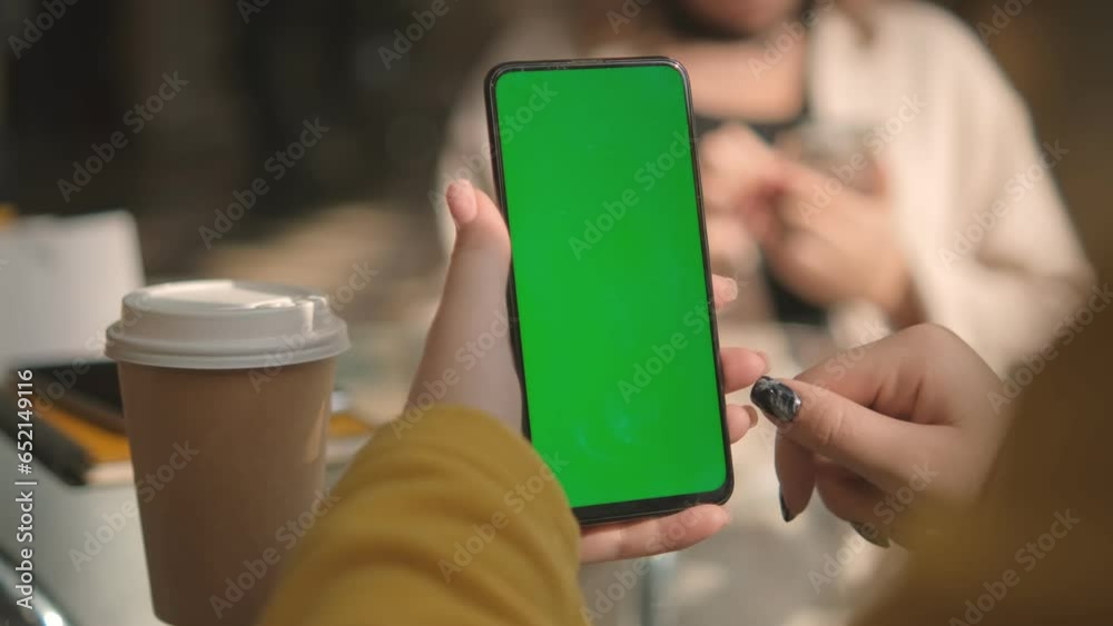 Lady sitting in the food area of the mall using smartphone viewing ...