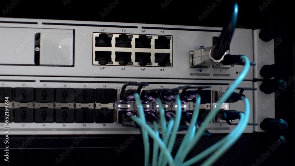 LAN and Fibre Optic Cables Plugged In Network Server Rack With White Blinking Lights. Close Up ...