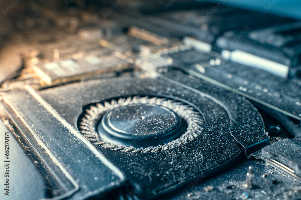 Laptop cooling cooler in dust close-up. Dirt inside the old computer ...