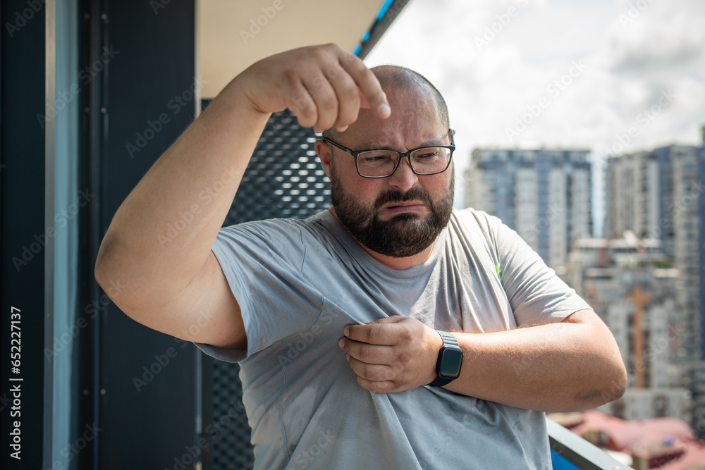 Man with wet armpits and disgusted expression on face. Fat obese young ...