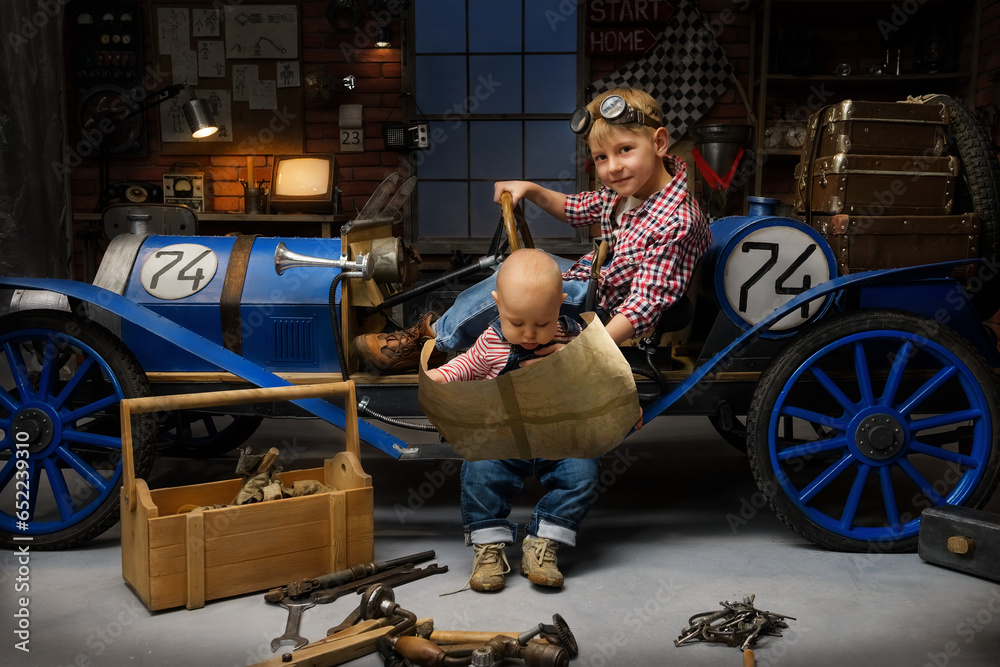 Little boys play in the garage and pretend they are mechanics. Children ...