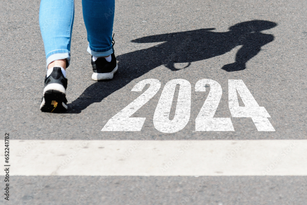 People walking on the crosswalk with new year number 2024.New future ...