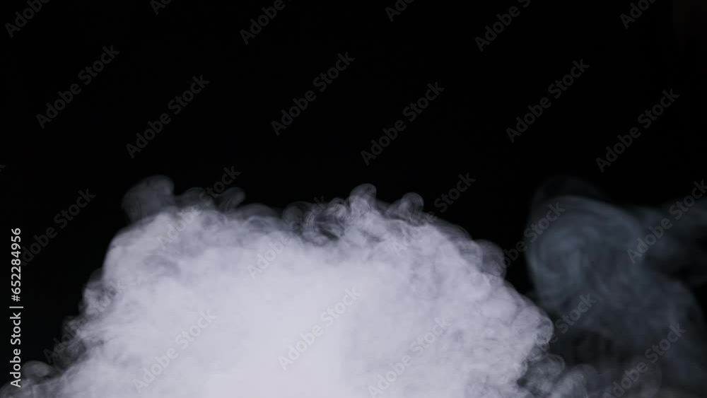 Jet stream of smoke or vapor on black background in slow motion 4K ...