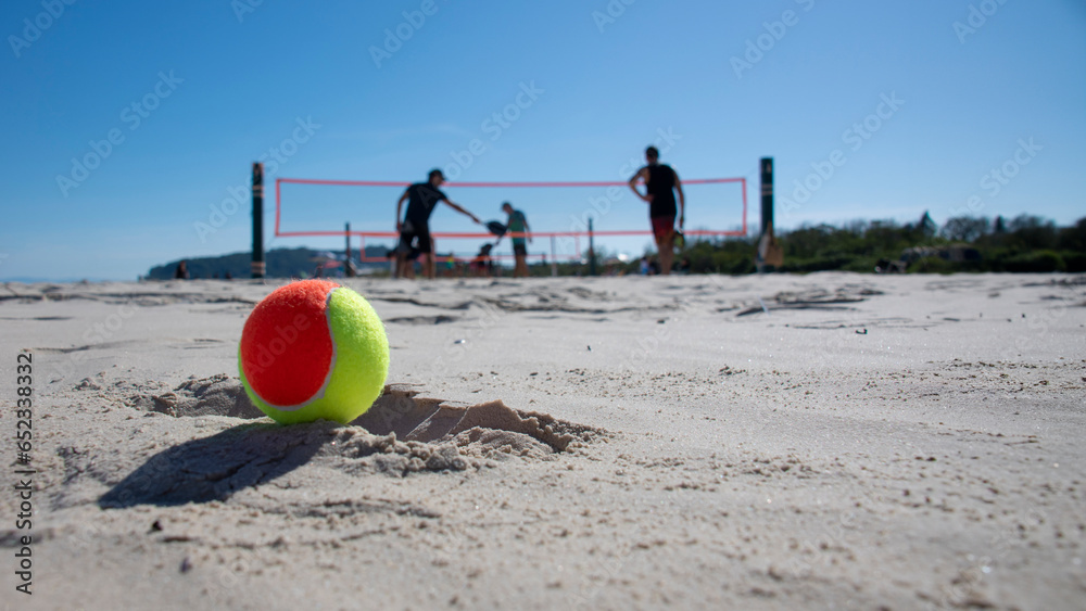 Doubles beach tennis game on the beach with blue sky and beach tennis ...