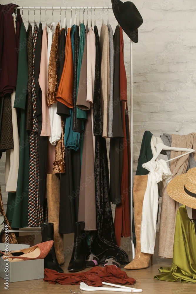 Untidy cluttered woman wardrobe with stylish clothes and accessories ...