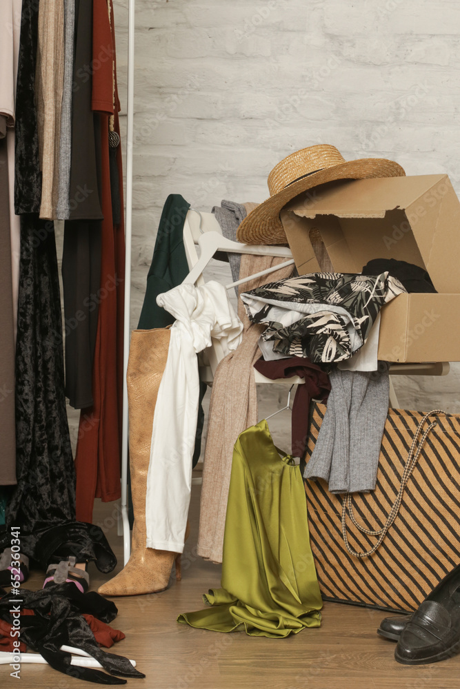 Untidy cluttered woman wardrobe with stylish clothes and accessories ...