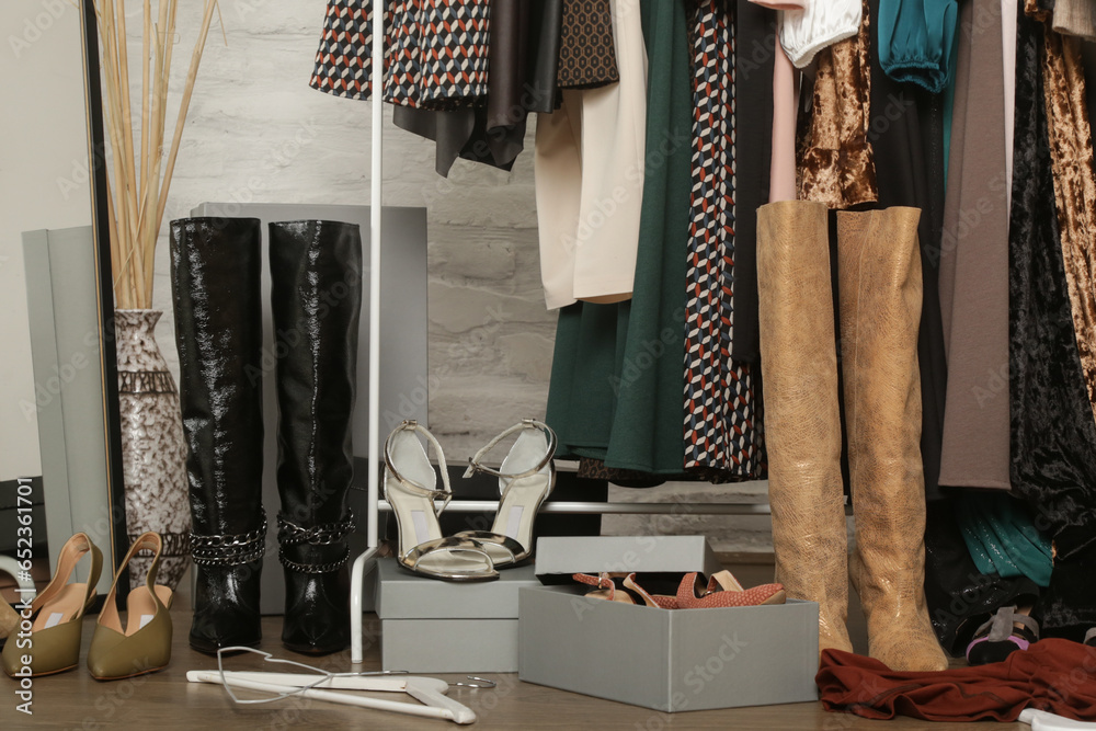 Untidy cluttered woman wardrobe with stylish clothes and accessories ...