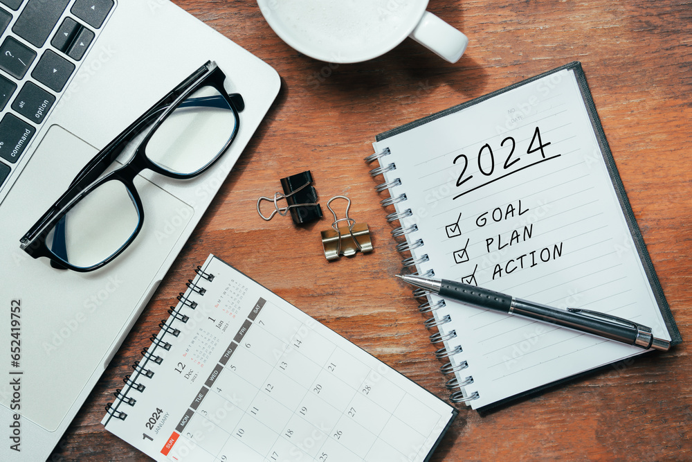 New Year's resolutions 2024 on wooden table. Goals, plans and action ...