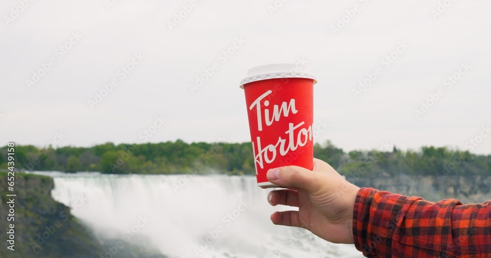 Toronto, Canada - May 6, 2023: Hand holds red Tim Horton coffee cup ...