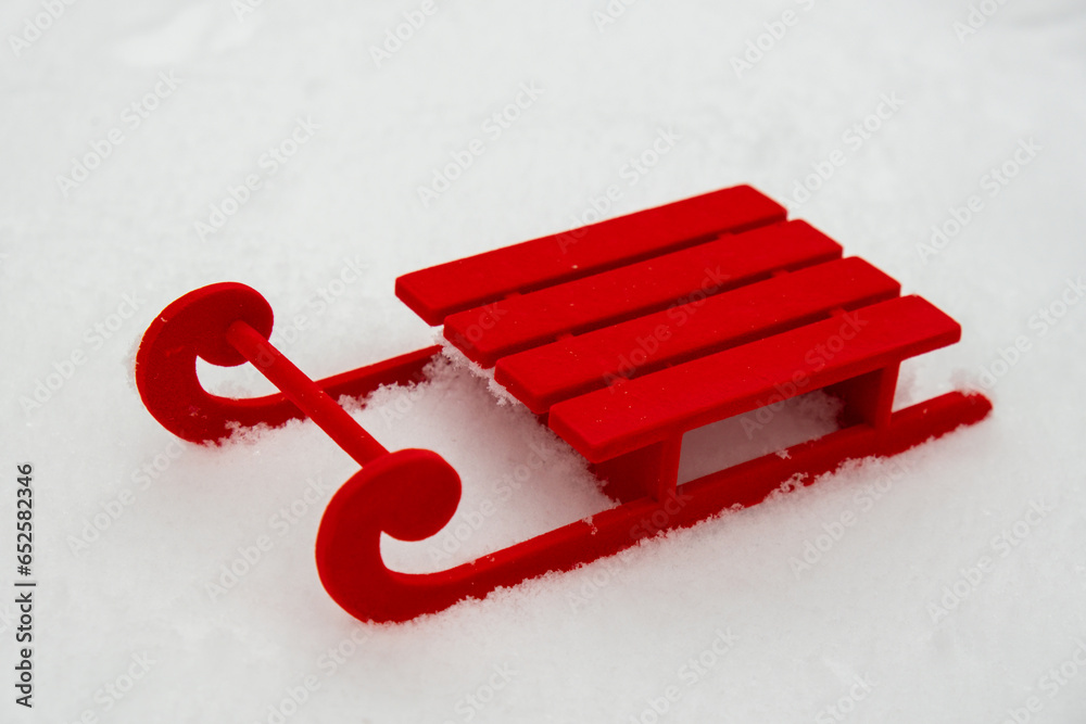 Small Red sled on snow background in beautiful winter day. Copy space ...