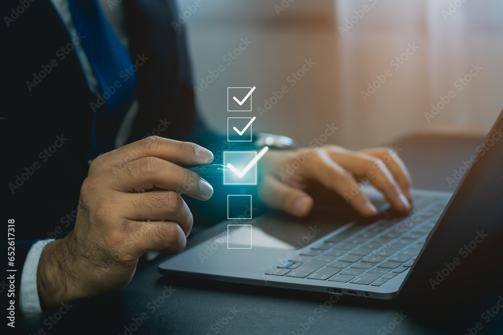 Businessman using digital pen to tick correct sign mark in virtual ...