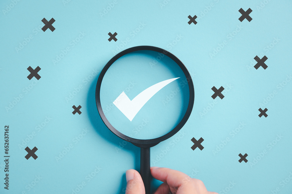 Magnifier enlarging the correct or check mark on gray background ...