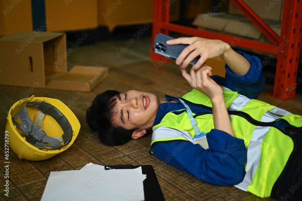 Male worker trying to making an emergency call, asking for first aid ...