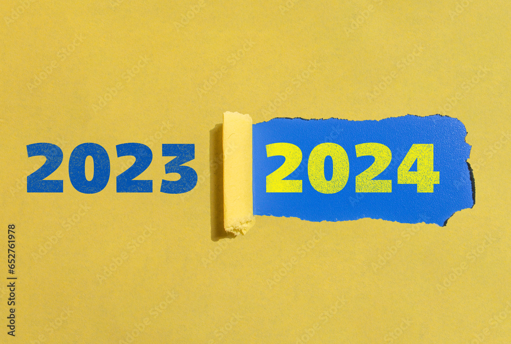 2023 turn to 2024. Year 2024 lettering on torn paper. New year coming ...