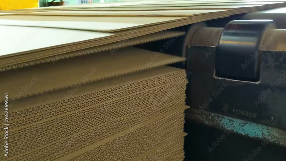 Stacker. Production of corrugated cardboard. Corrugated sheets are ...