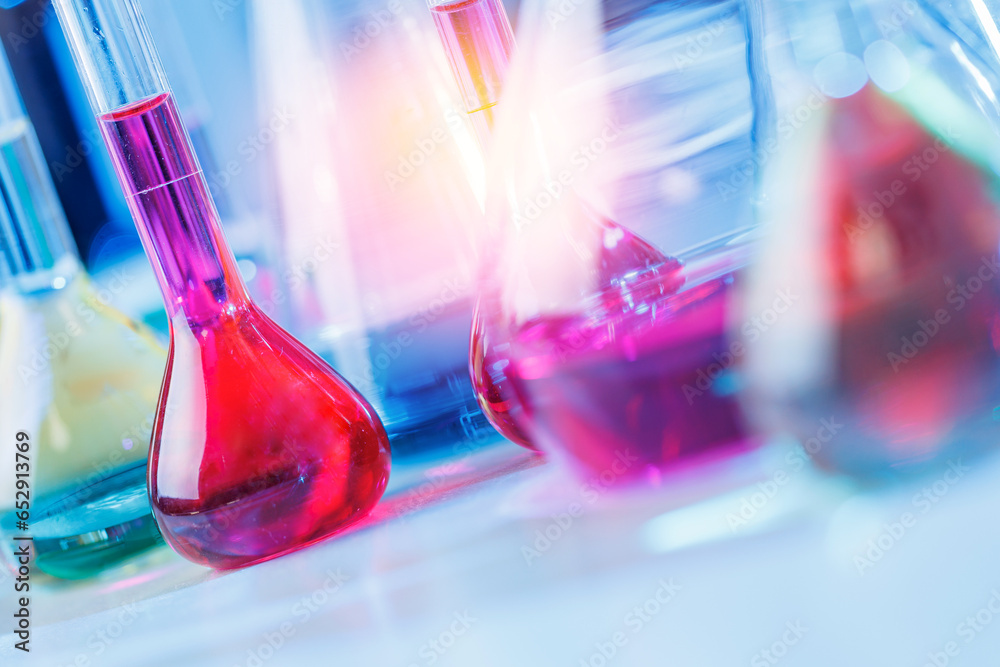 Purple and blue color glass flask in white light background. Concept ...