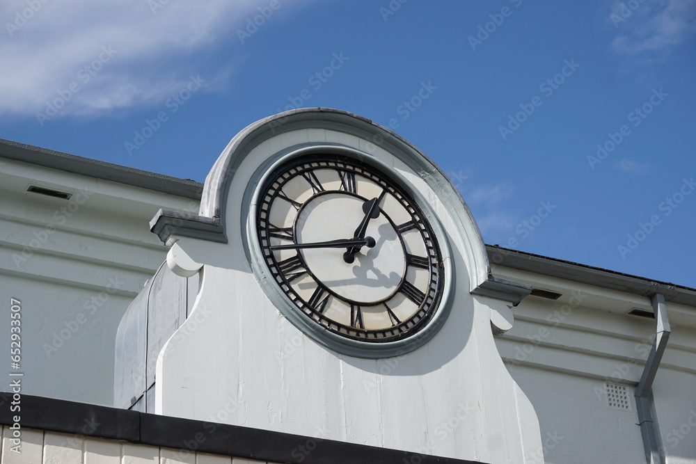 vintage clock face on building exterior. clock dial with Roman Numerals ...