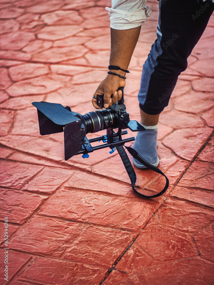 Filmmaker touring the city with his camera taking images for his film ...