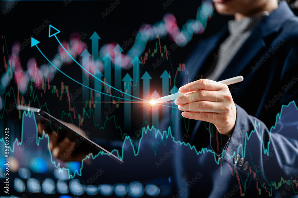 Businesswomen use digital tablets analyze to virtual screens of graph ...