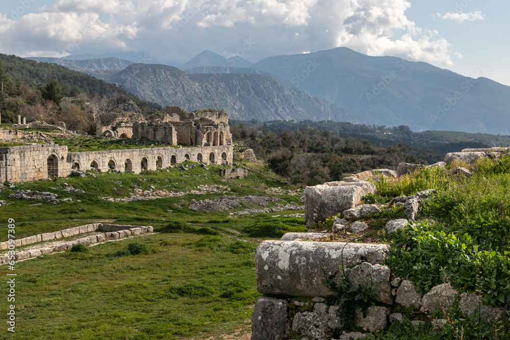 Gray rock-cut ancient ruins and ruined dead city: carved windows ...