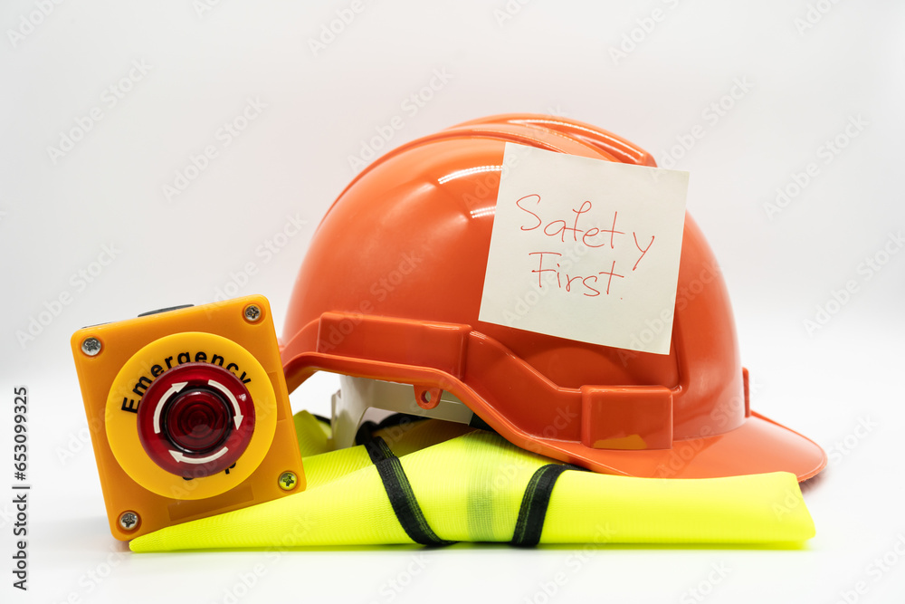 Safety First message on paper. Safety Gear. Reflective vest, safety hat ...