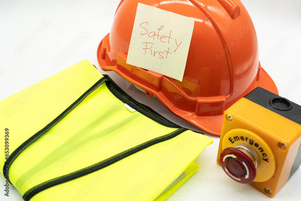 Safety First message on paper. Safety Gear. Reflective vest, safety hat ...
