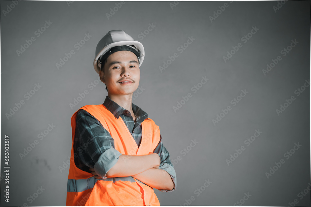 Asian engineer handsome man is standing on gray background of concrete ...