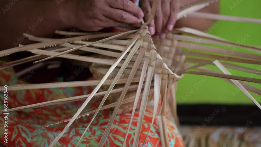 An Indonesian woman´s hand weaving an ancestral basket case from ...