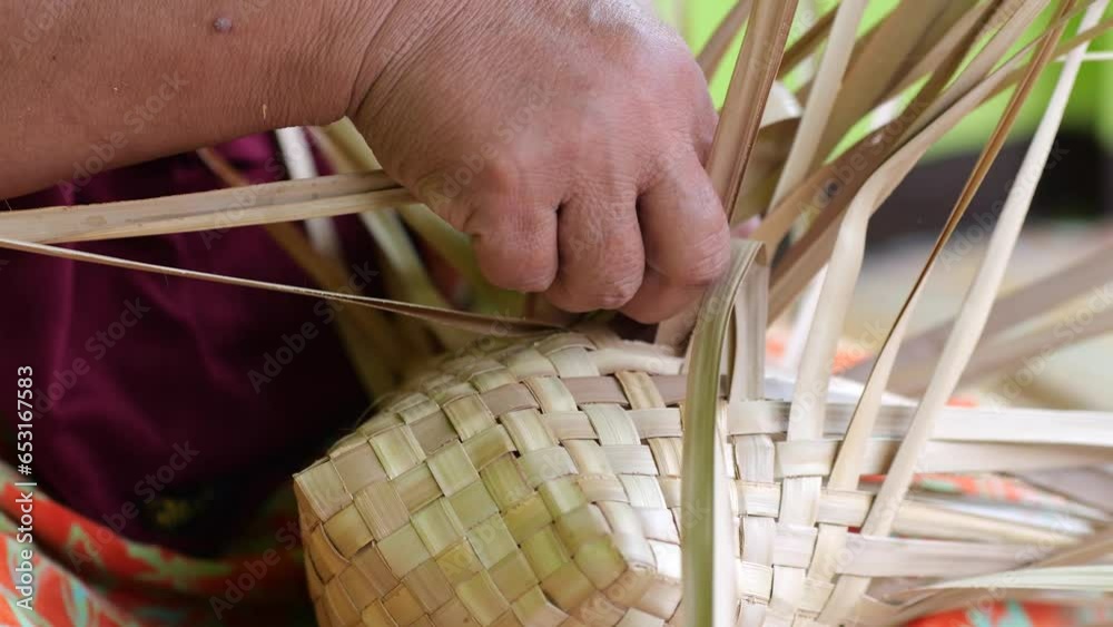 An Indonesian woman´s hand weaving an ancestral basket case from ...