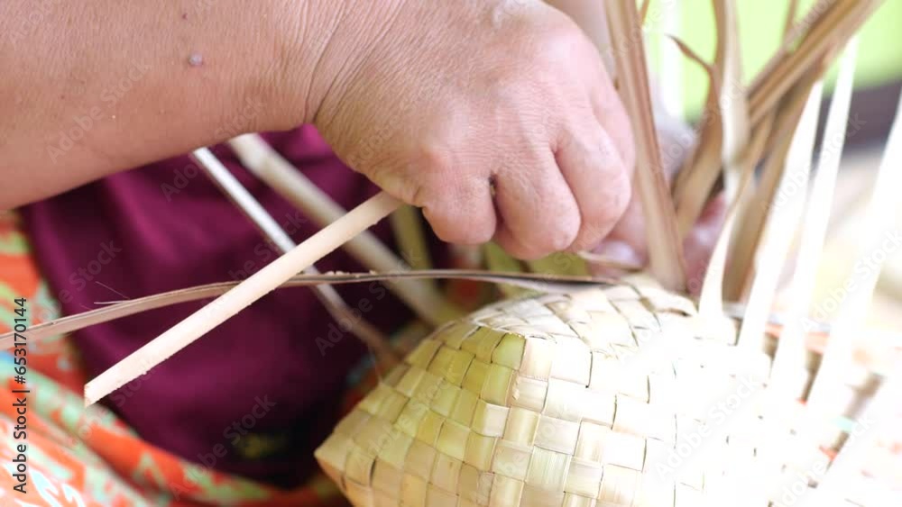 An Indonesian woman´s hand weaving an ancestral basket case from ...