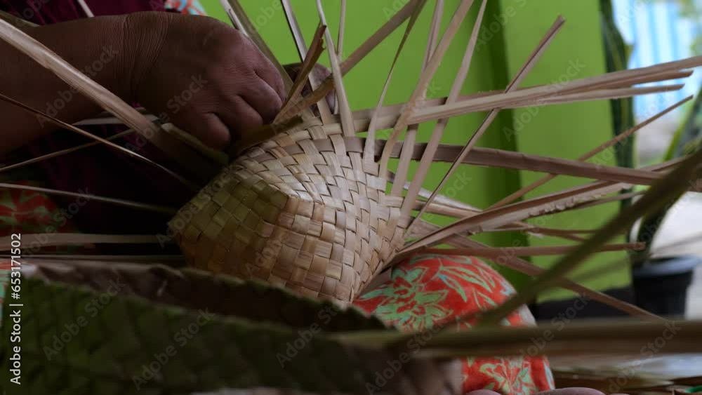 An Indonesian woman´s hand weaving an ancestral basket case from ...