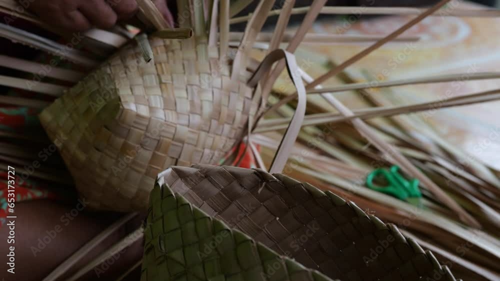An Indonesian woman´s hand weaving an ancestral basket case from ...