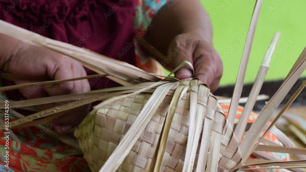 An Indonesian woman´s hand weaving an ancestral basket case from ...