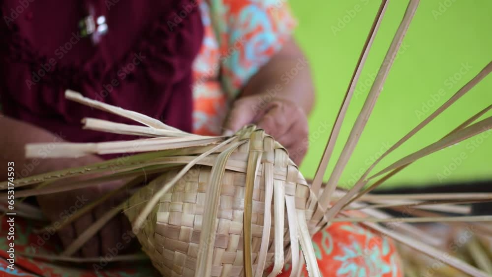 An Indonesian woman´s hand weaving an ancestral basket case from ...