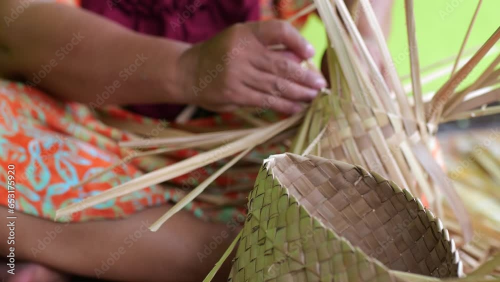 An Indonesian woman´s hand weaving an ancestral basket case from ...
