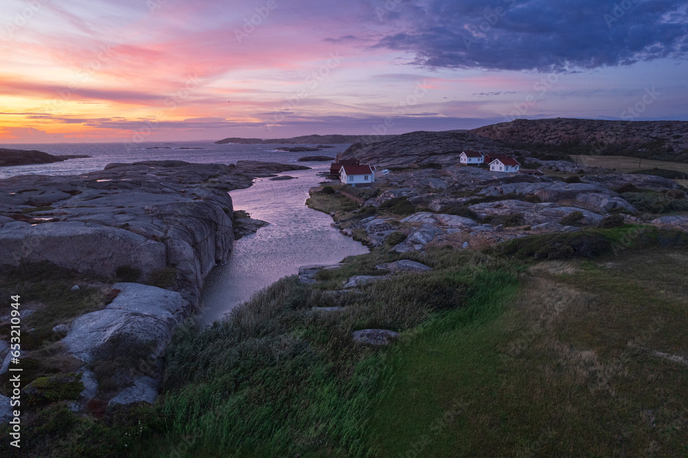 Dusk time on Ramsvik island with isolated houses on granite rocks ...