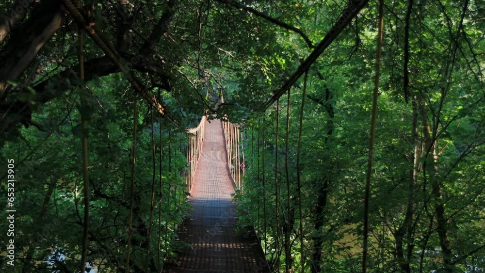 Walk along the iron bridge that hangs over the river. The iron ...