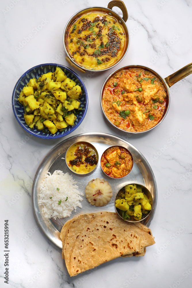 Indian vegetarian Thali or platter includes Aloo ki sabji, dal rice ...