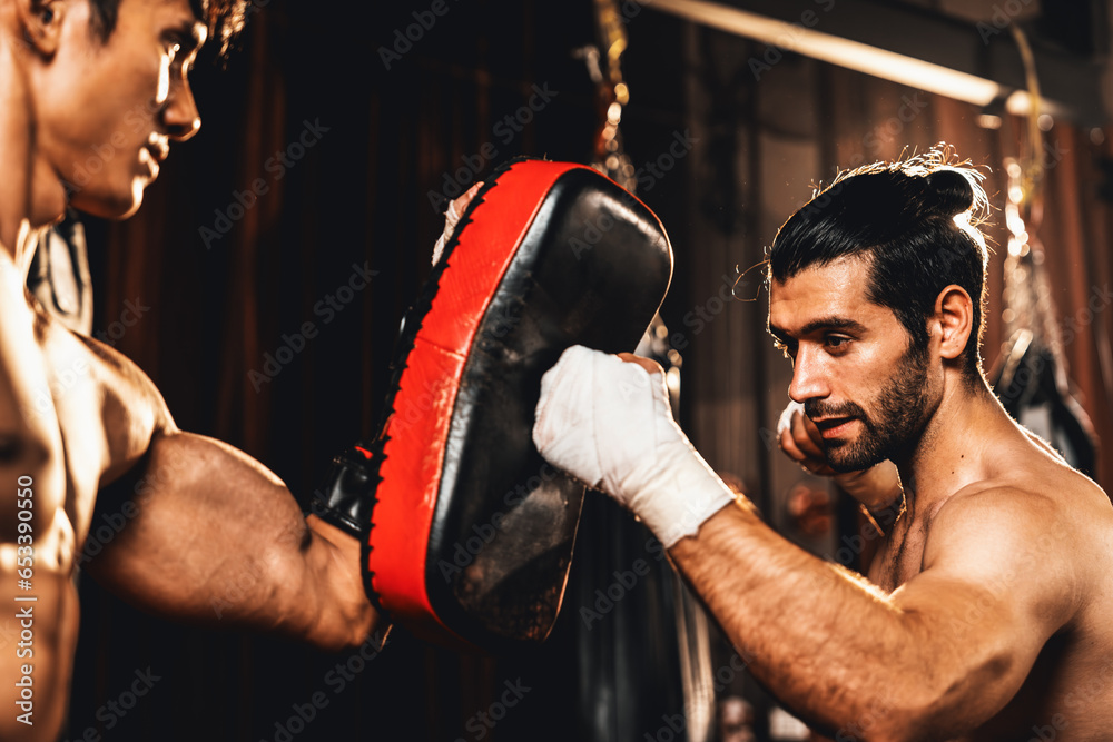 Asian and Caucasian Muay Thai boxer unleash punch in fierce boxing ...
